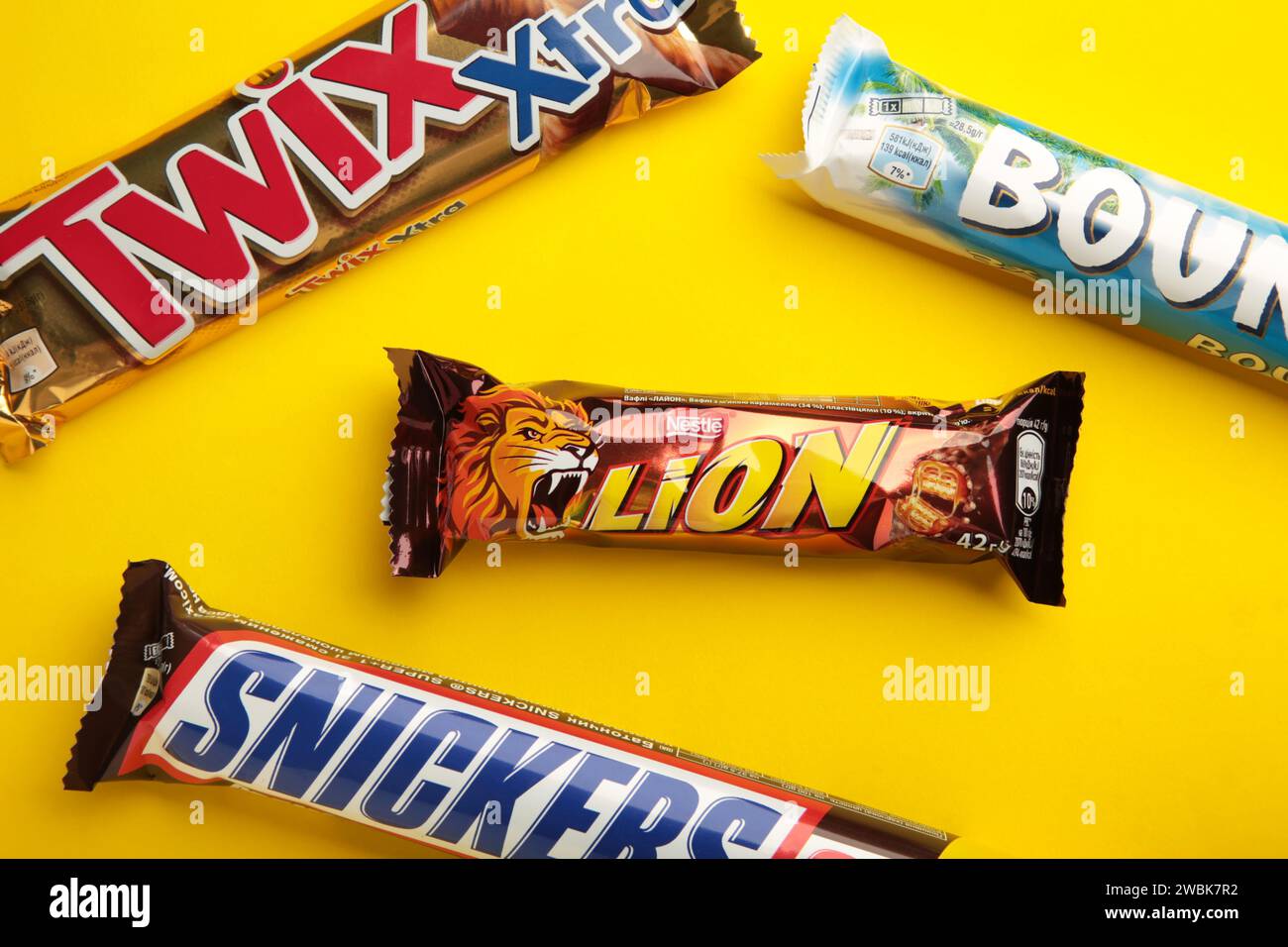 Snickers, Mars, Bounty and Twix chocolate bars on yellow background ...