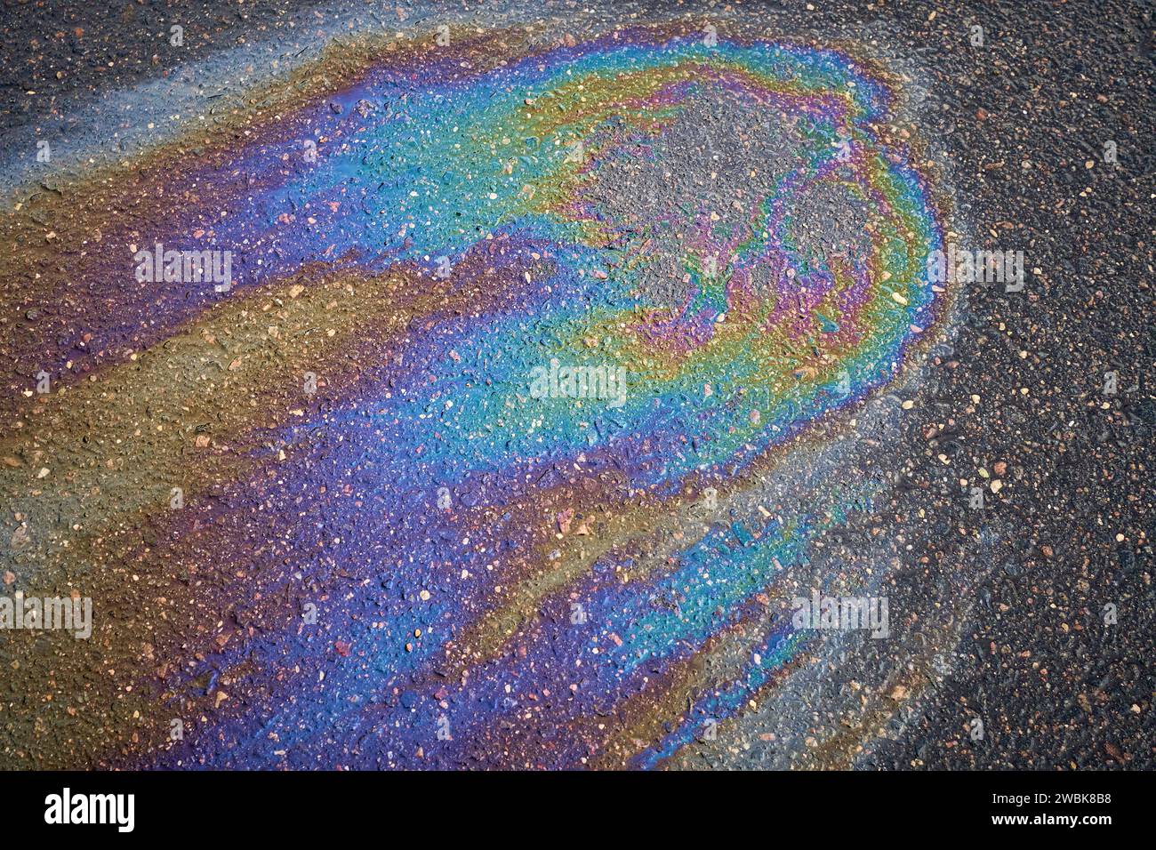Texture of colorful petrol oil spill on wet pavement. Slick industry ...