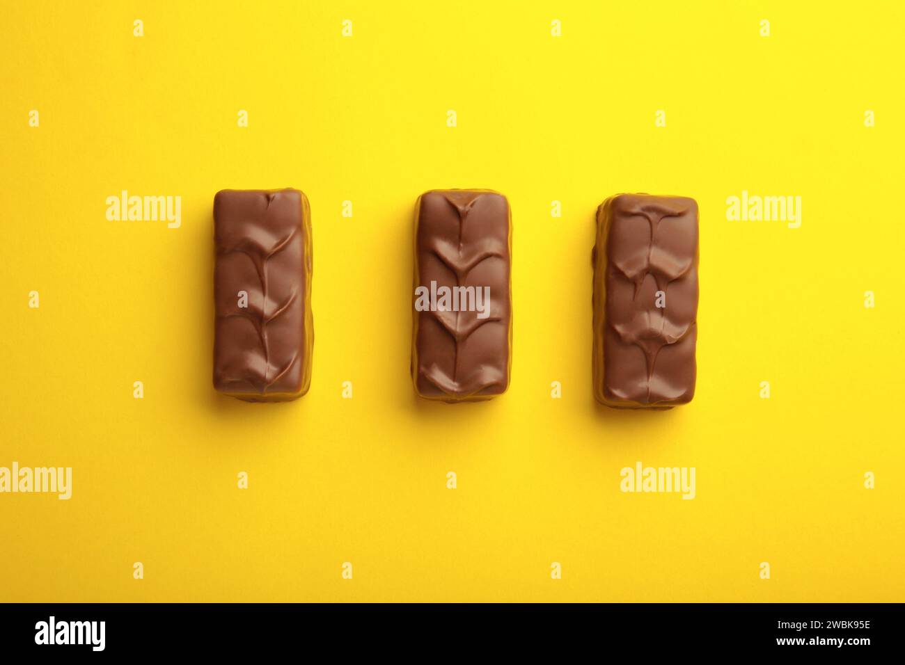 Mix of chocolate bars on yellow background Stock Photo - Alamy