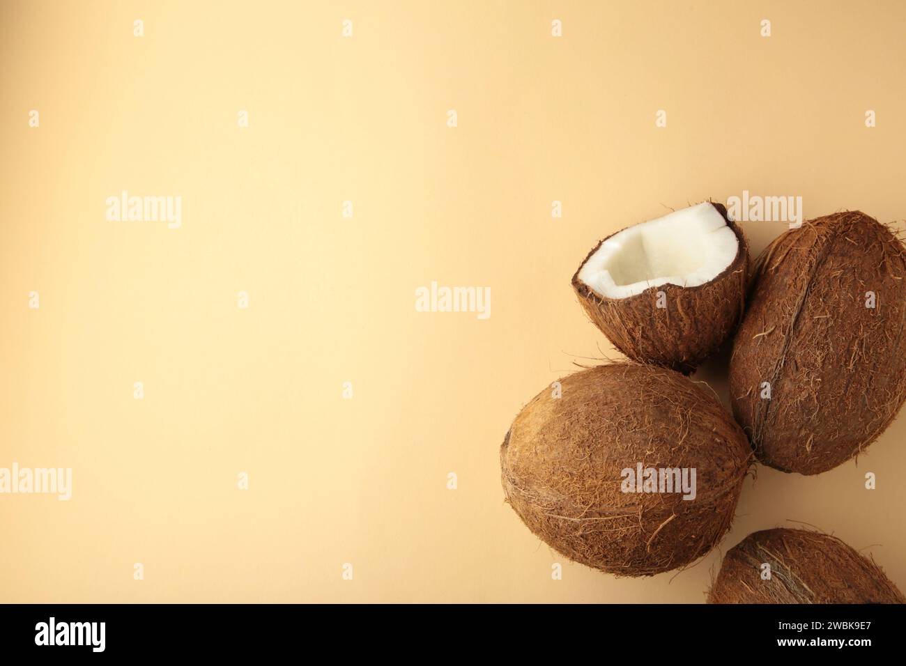 Coconut on a beige background. Halves and whole coconuts Stock Photo ...