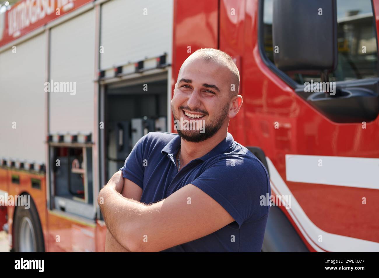 Confident firefighter stands with crossed arms, exuding resilience and ...