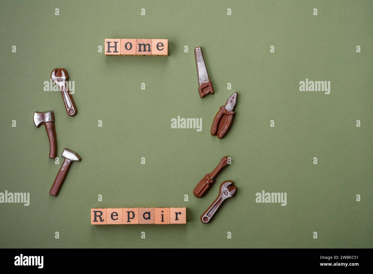 Repair or home improvement tools and a house model on a plain ...