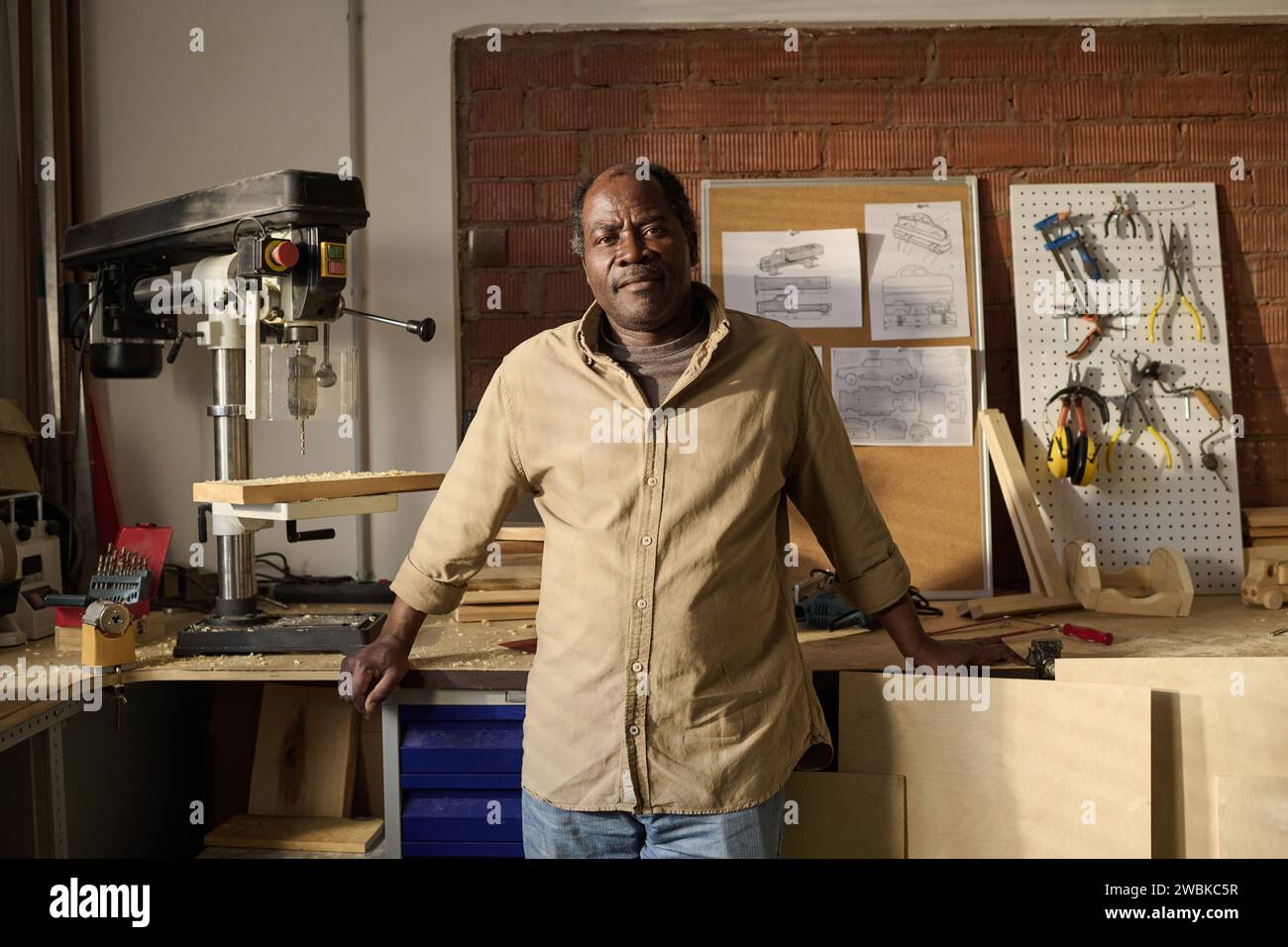 Senior black craftsman standing in hi-res stock photography and images ...