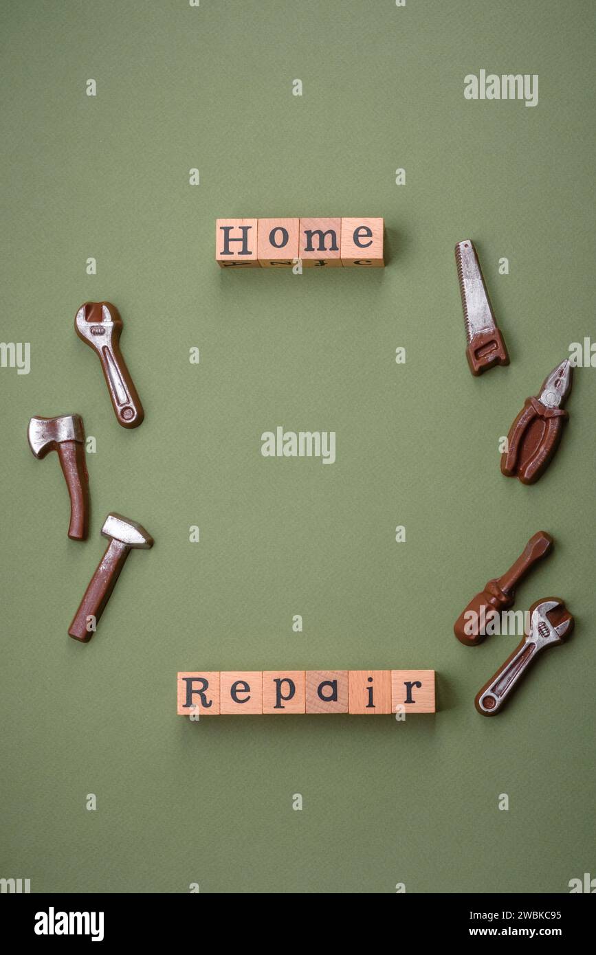 Repair or home improvement tools and a house model on a plain ...