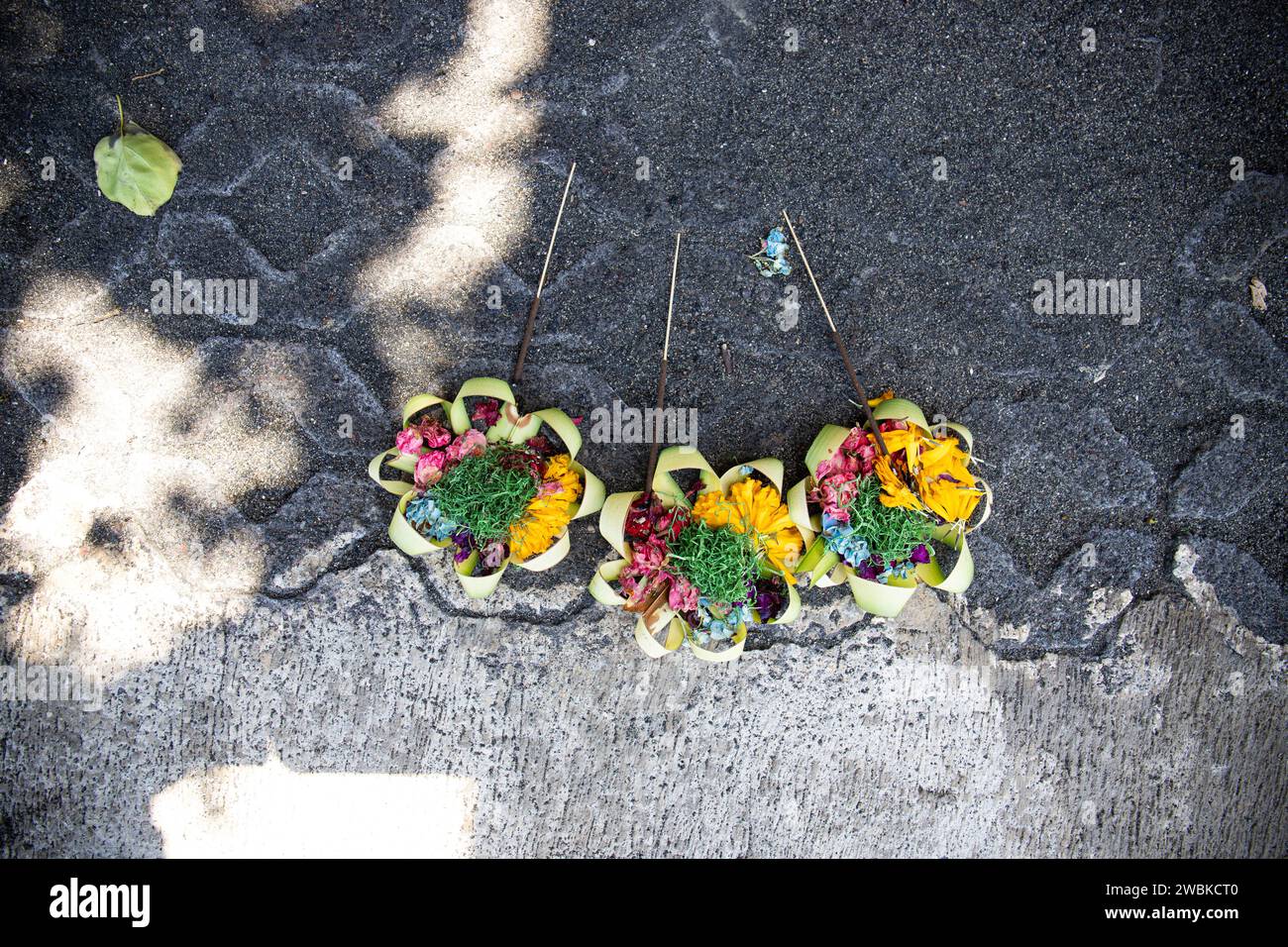 Three beautiful colorful opera bowls on the roadside, flowers as an ...