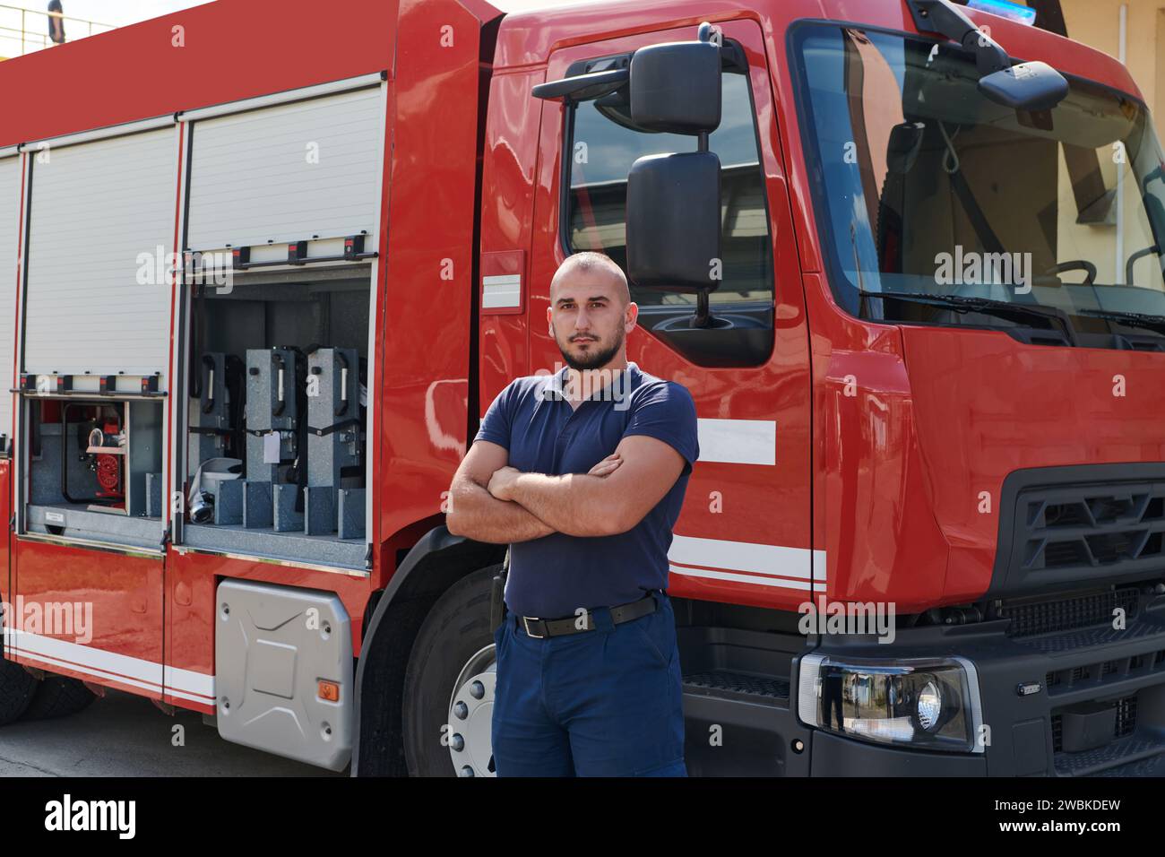 Confident firefighter stands with crossed arms, exuding resilience and ...