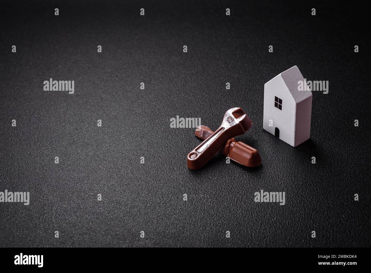 Repair or home improvement tools and a house model on a plain ...