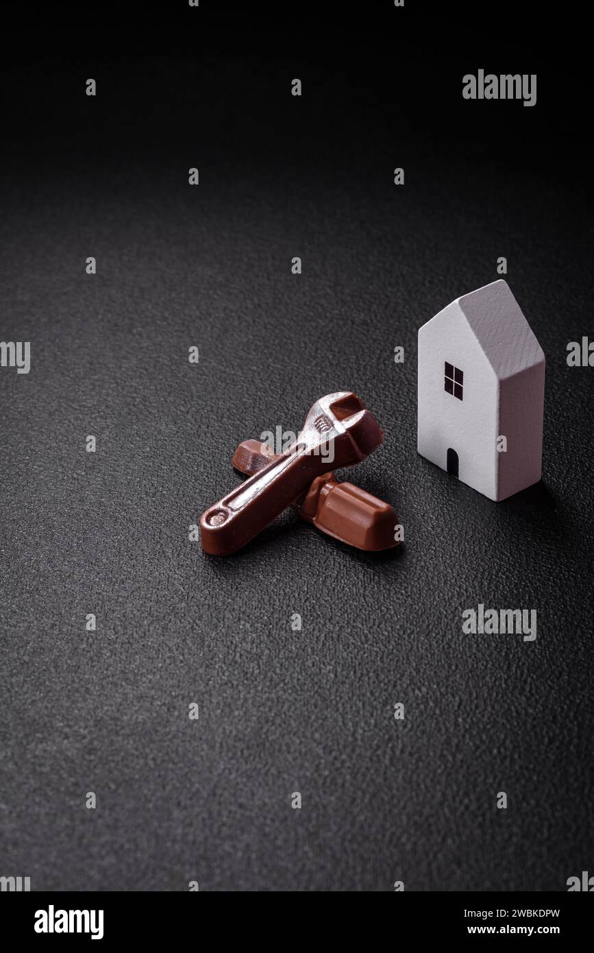 Repair or home improvement tools and a house model on a plain ...