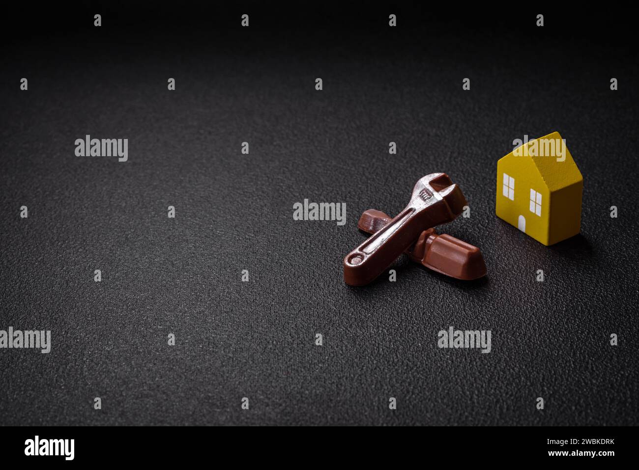 Repair or home improvement tools and a house model on a plain ...