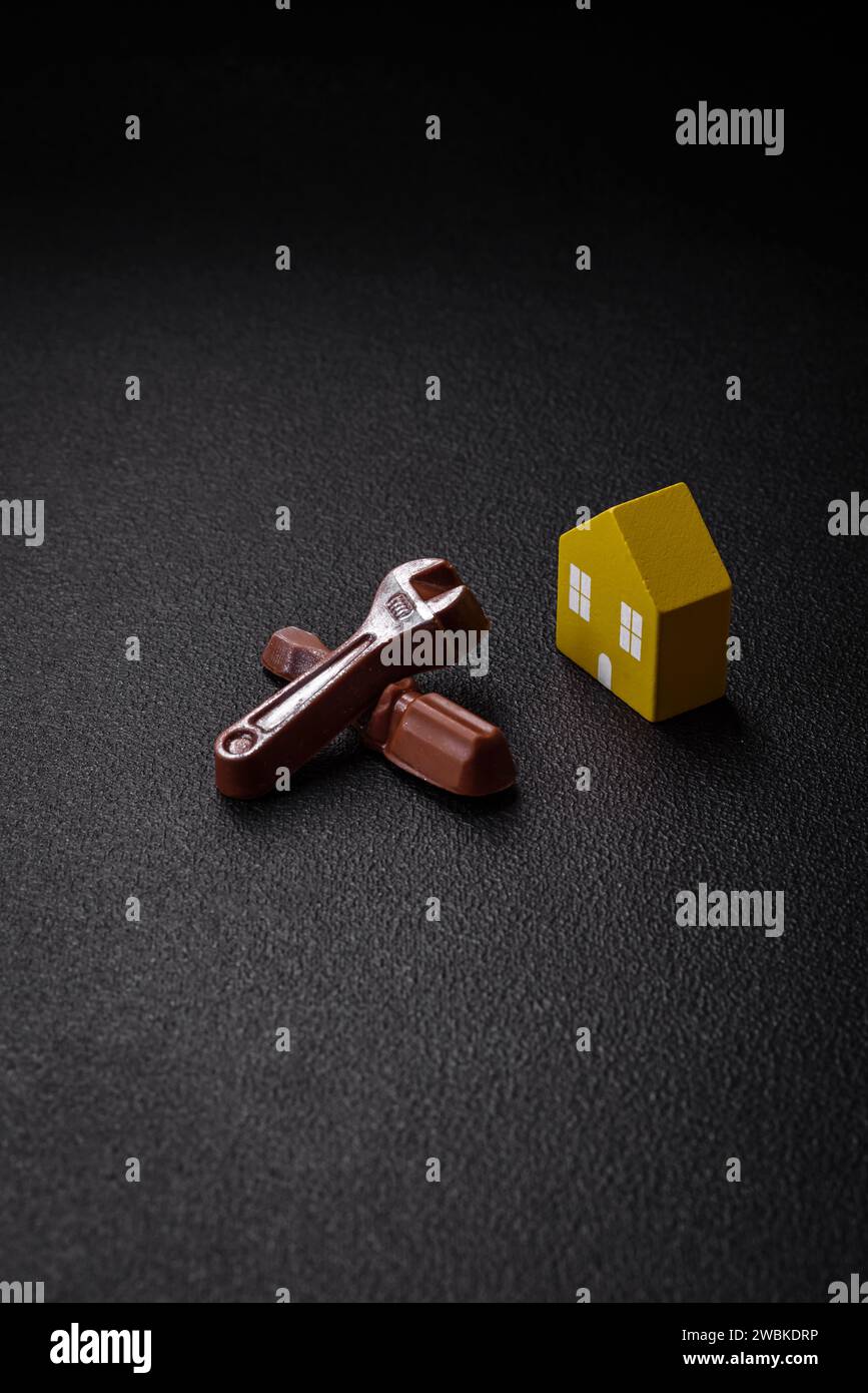 Repair or home improvement tools and a house model on a plain ...