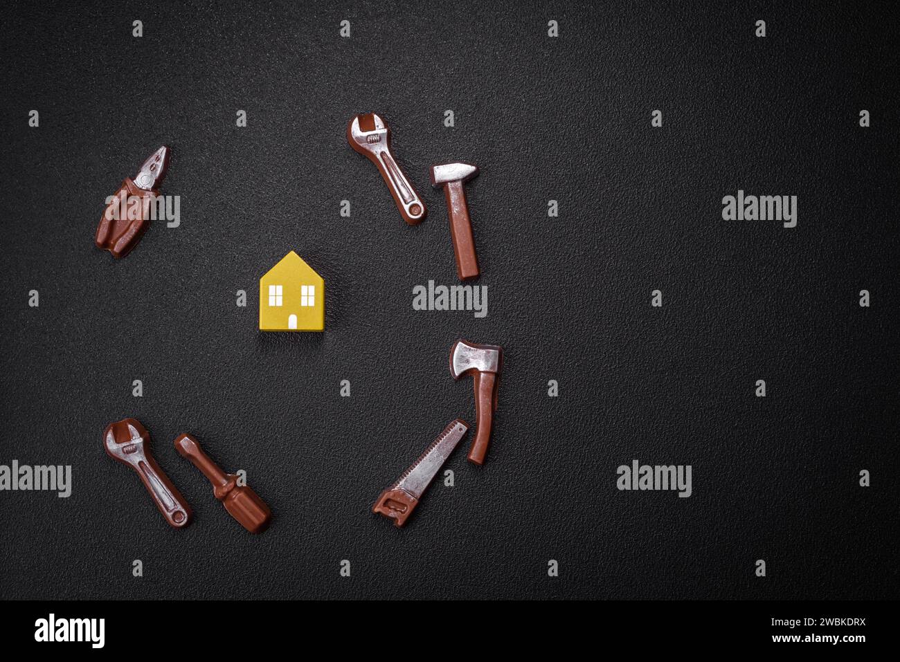 Repair or home improvement tools and a house model on a plain ...