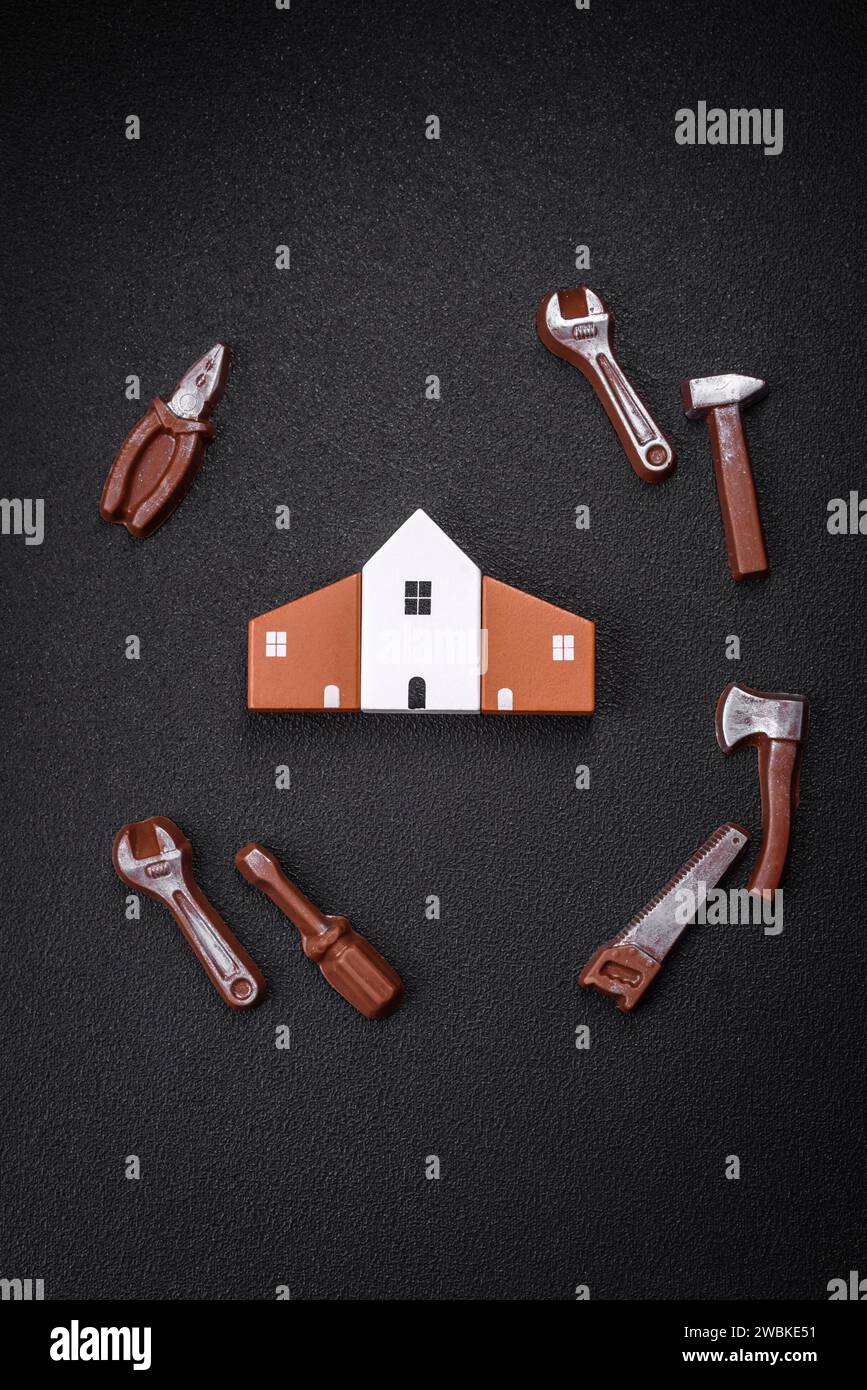 Repair or home improvement tools and a house model on a plain ...