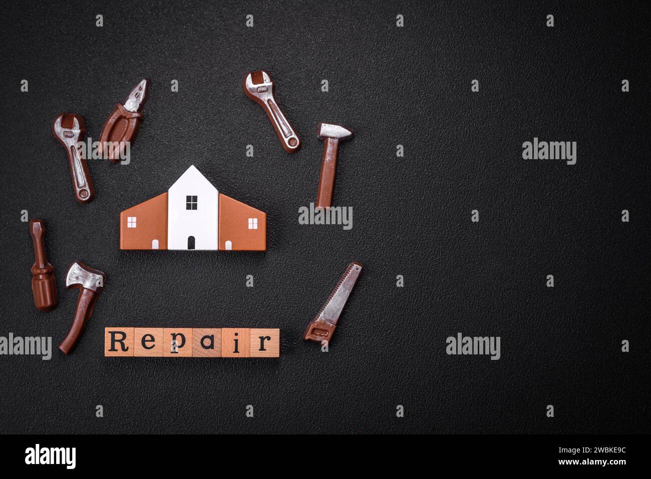 Repair or home improvement tools and a house model on a plain ...