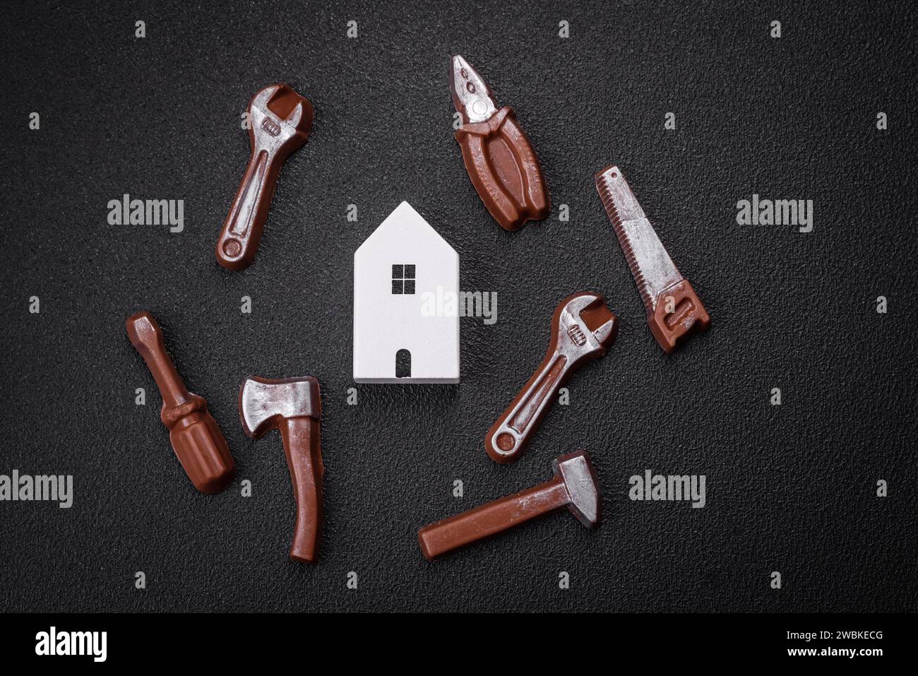 Repair or home improvement tools and a house model on a plain ...