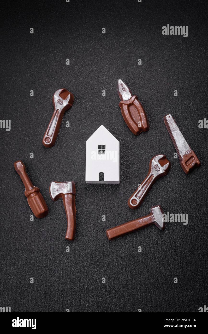 Repair or home improvement tools and a house model on a plain ...
