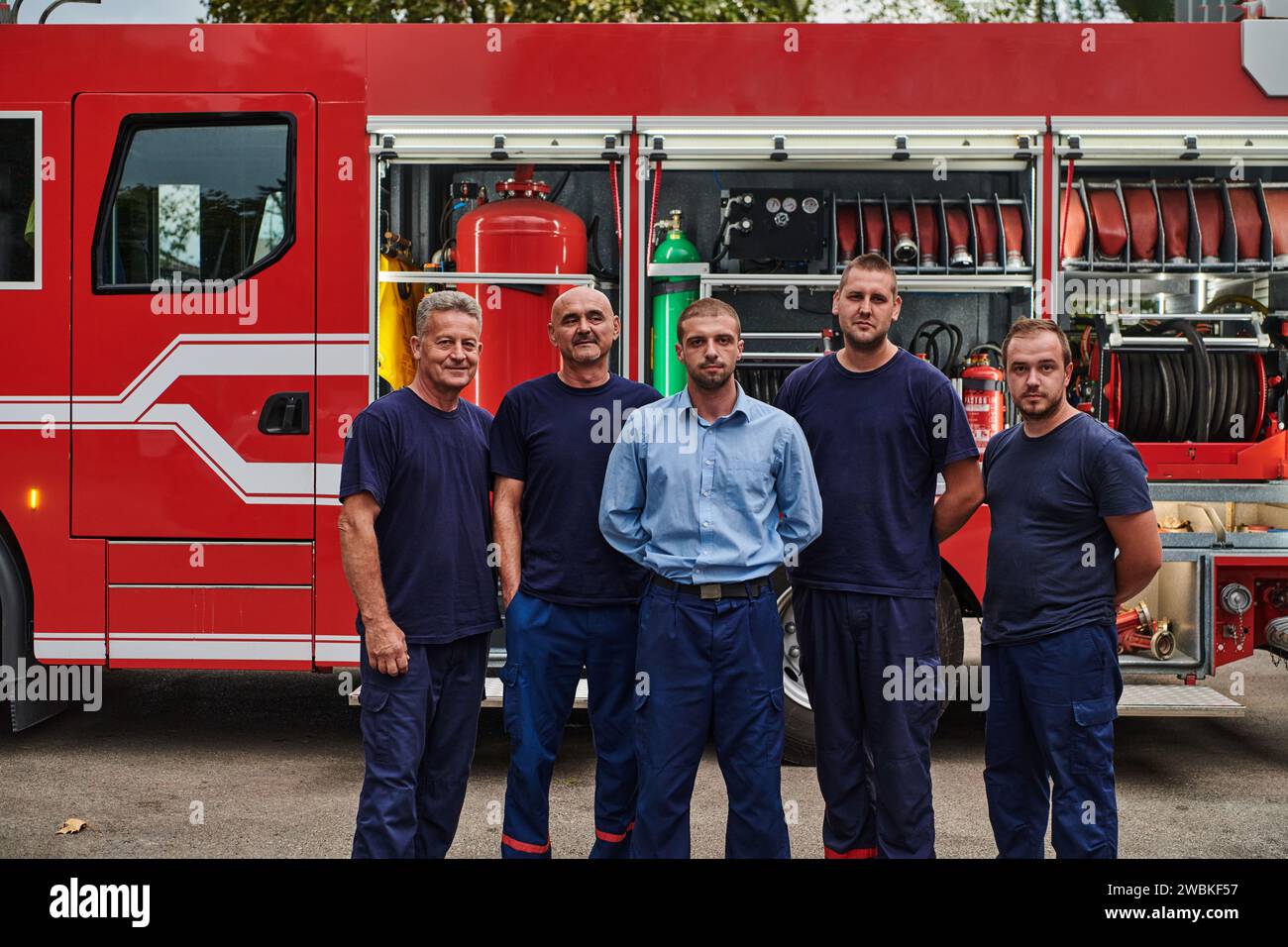 A skilled and dedicated professional firefighting team proudly poses in ...