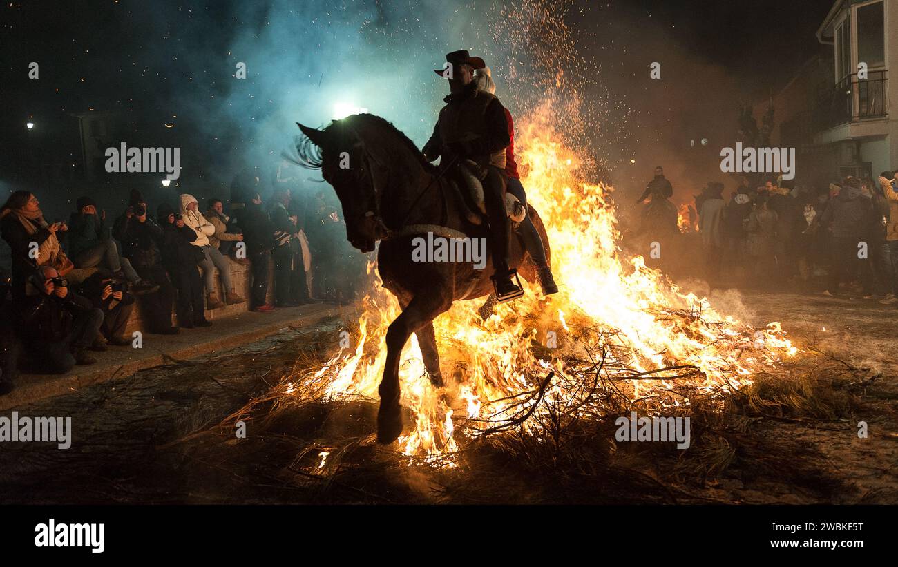 rider on his horse, next to the bonfire fire in the celebration of the ...