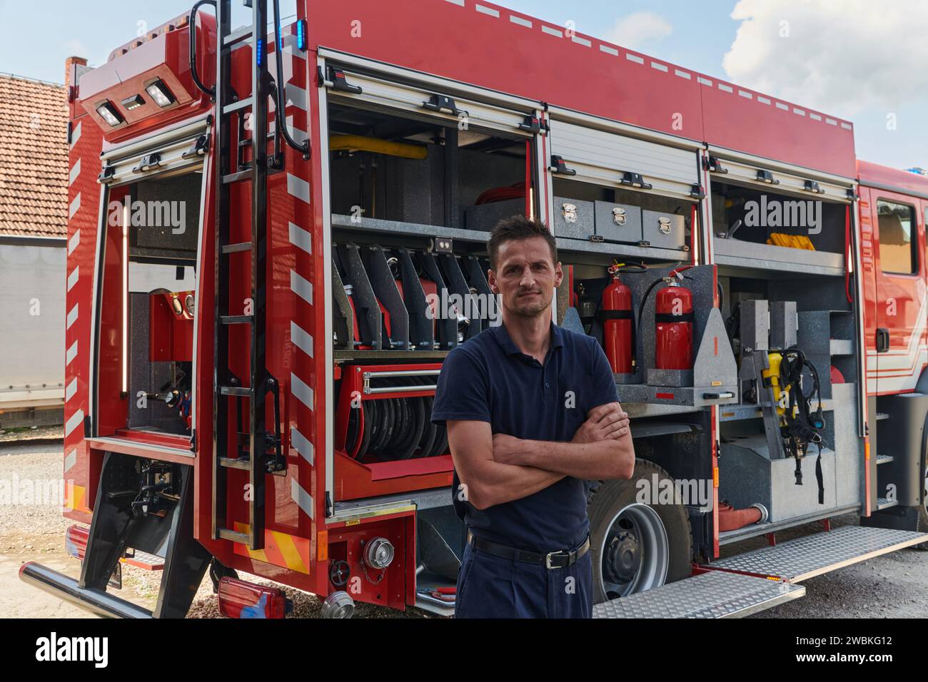 Confident firefighter stands with crossed arms, exuding resilience and ...