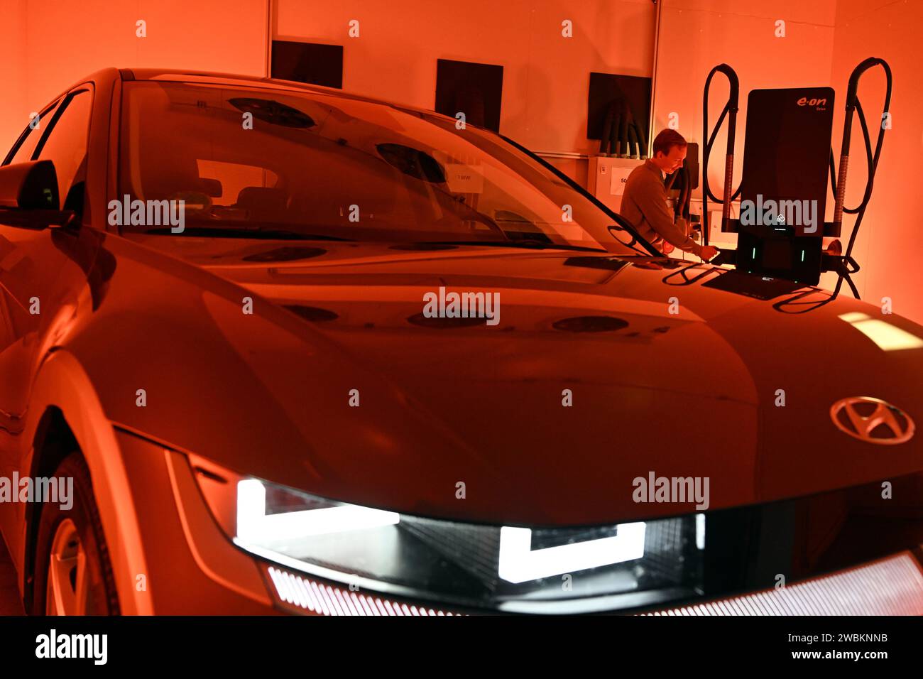 Essen, Germany. 11th Jan, 2024. An Eon employee operates a charging ...