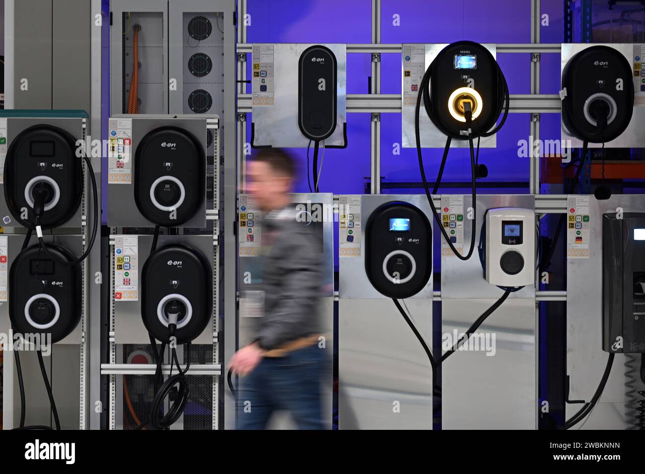 Essen, Germany. 11th Jan, 2024. An Eon employee walks past charging ...