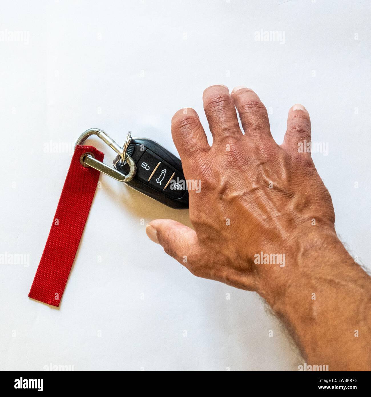 male hand with car key, white background Stock Photo - Alamy