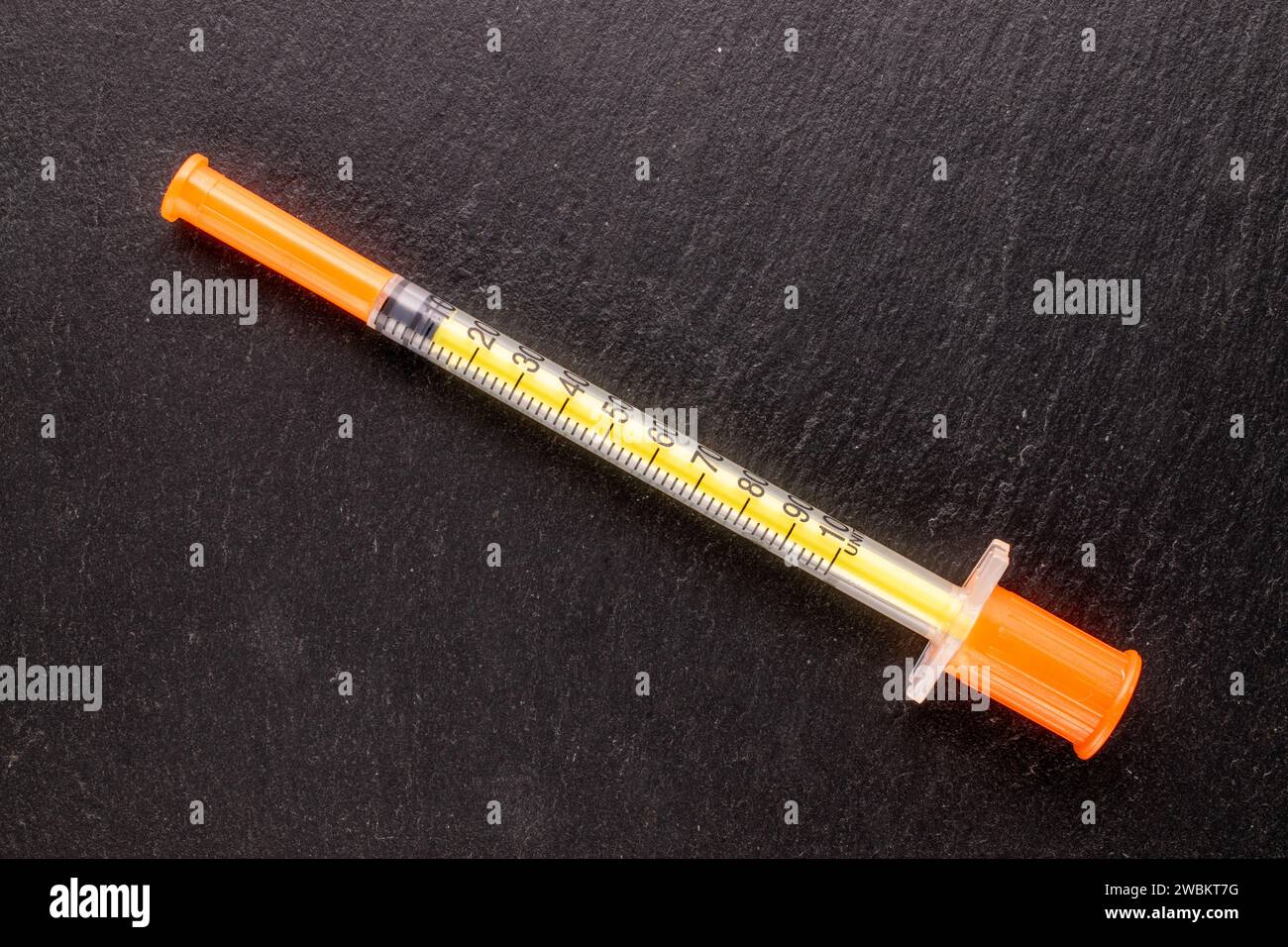 One medical syringe on slate stone, macro, top view Stock Photo - Alamy