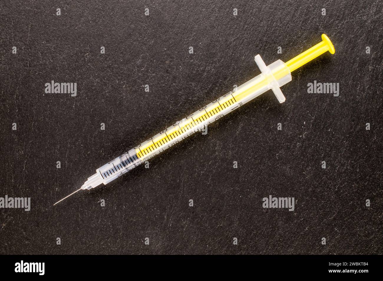 One medical syringe on slate stone, macro, top view Stock Photo - Alamy