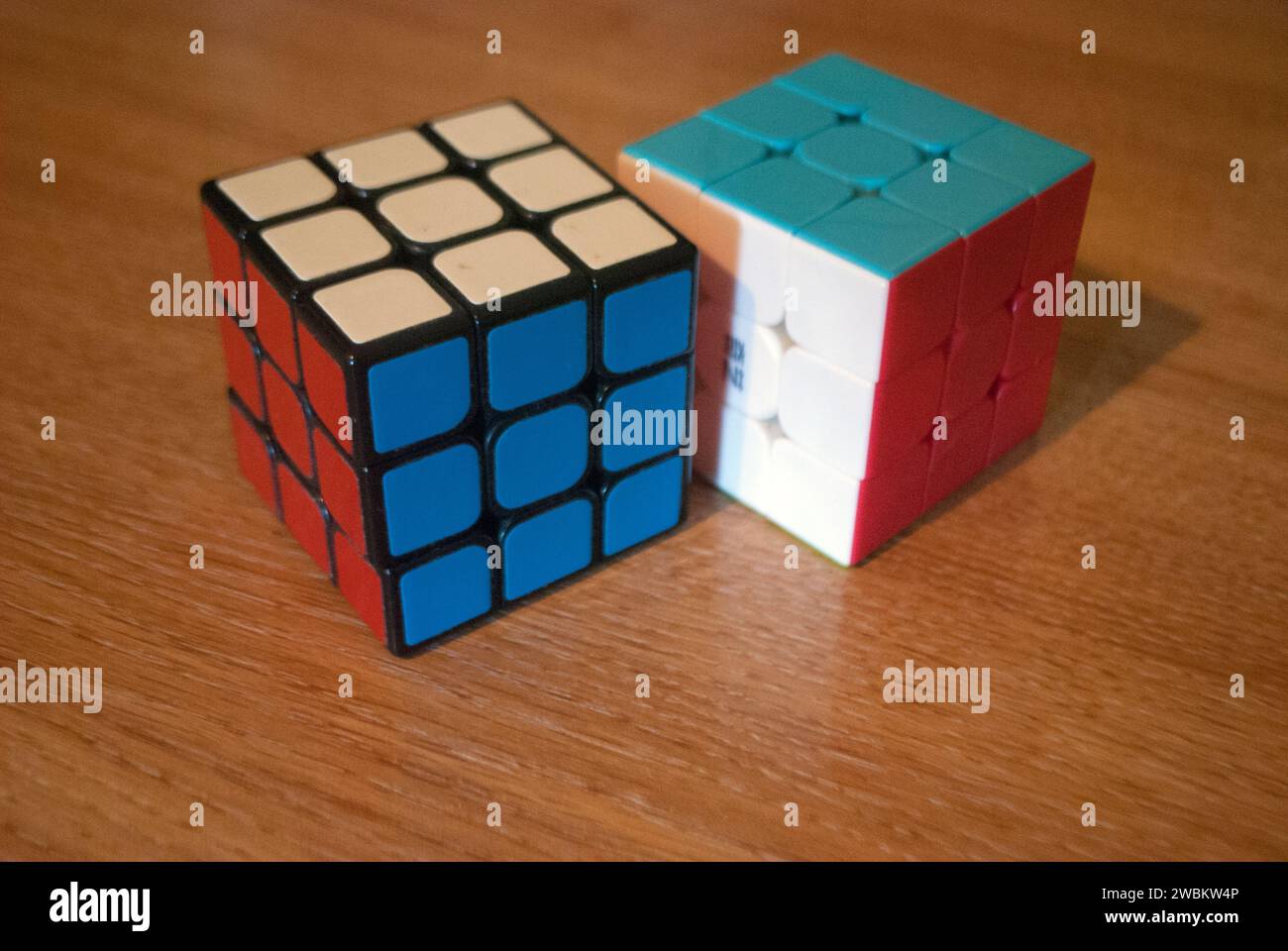 Two rubik's cubes on a desk showing red white and blue sides Stock ...