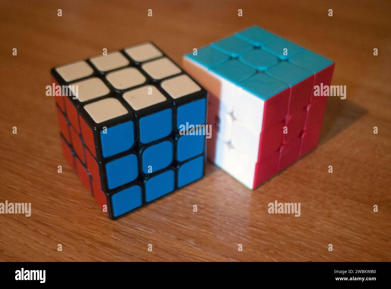 Two rubik's cubes on a desk showing red white and blue sides Stock ...