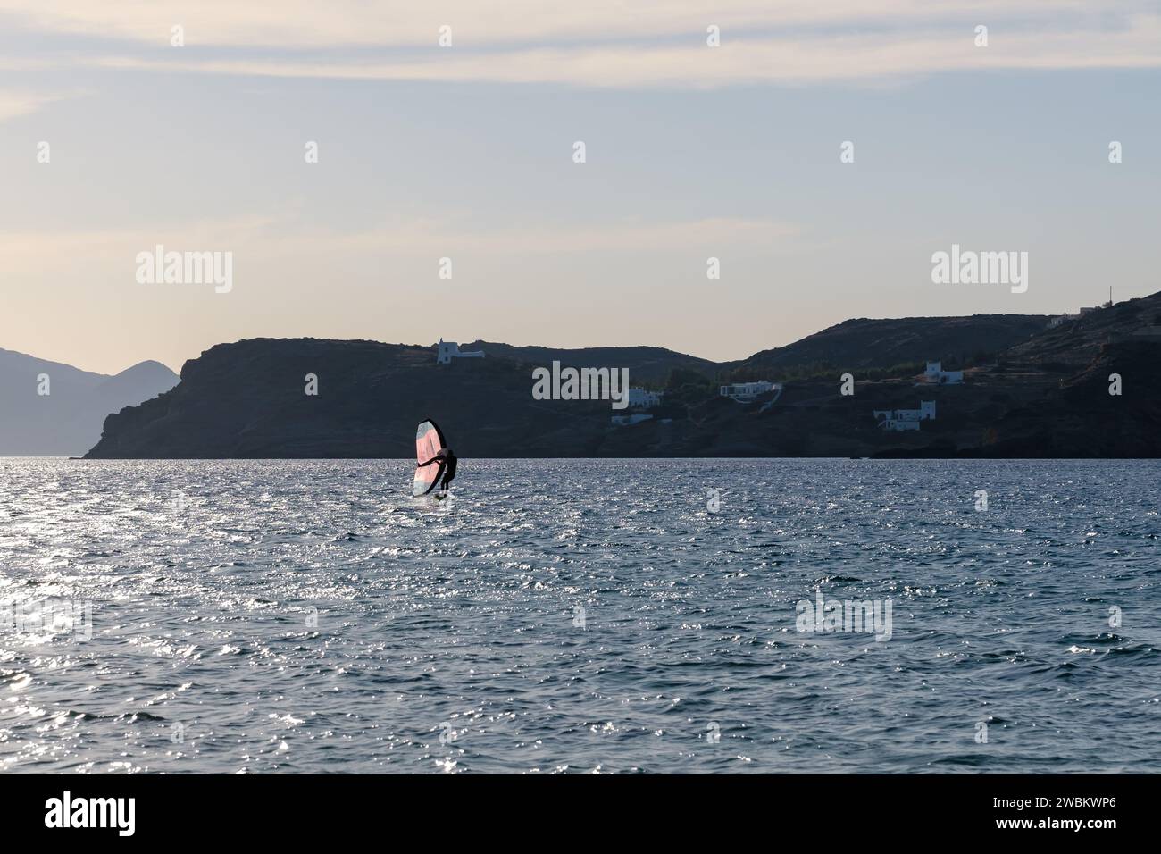 View of a tourist enjoying wing foil surfing at the Mylopotas beach in ...