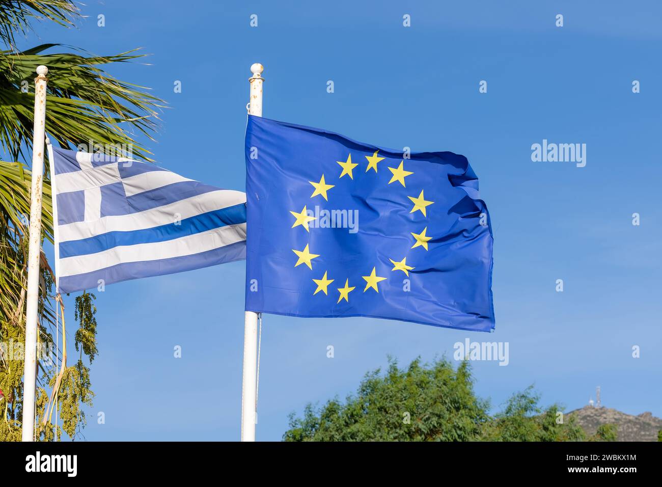 View the Greek national flag and the flag of the European community ...