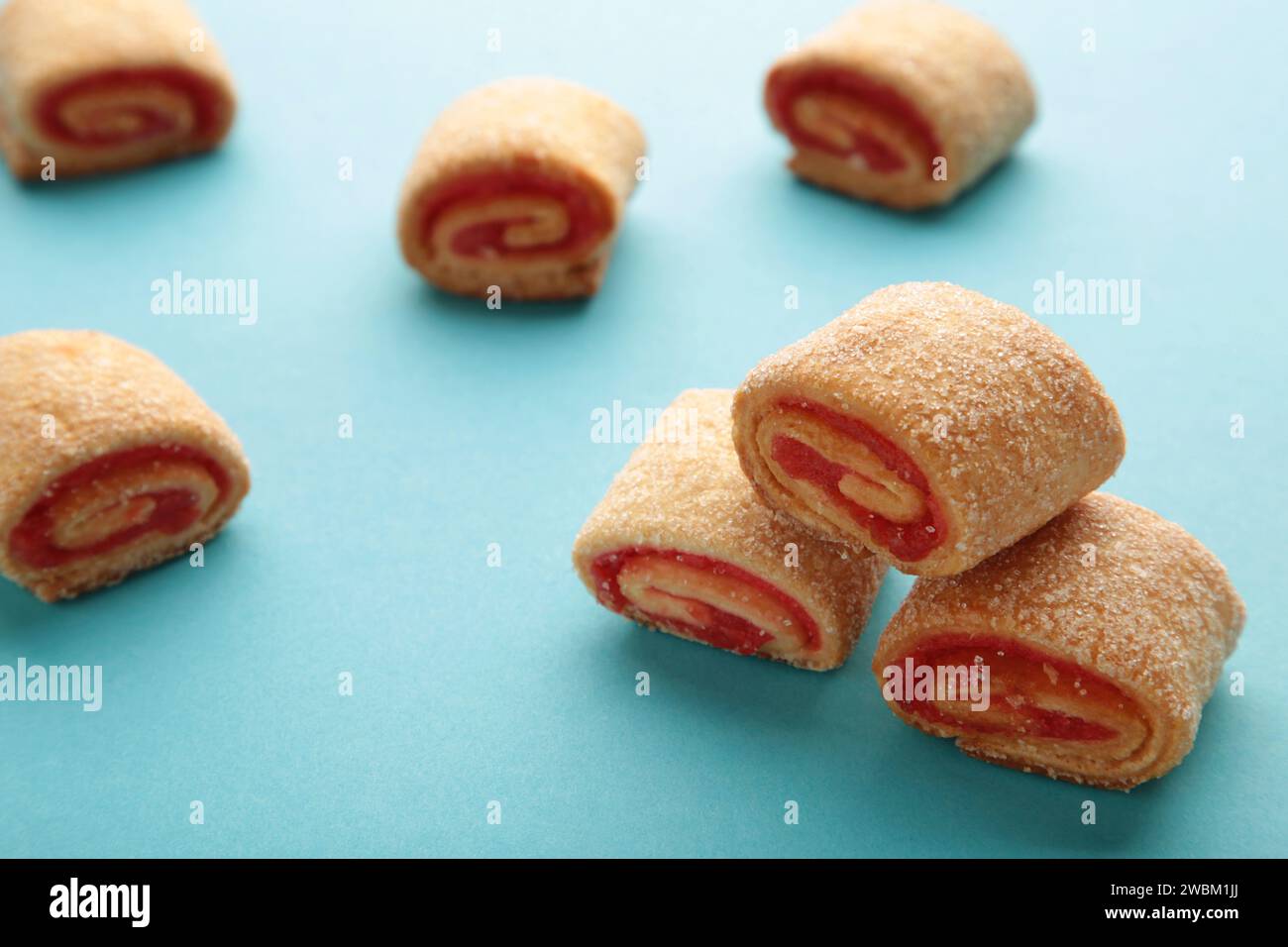 Homemade cookies, mini rolls with apricot jam on blue background Stock ...