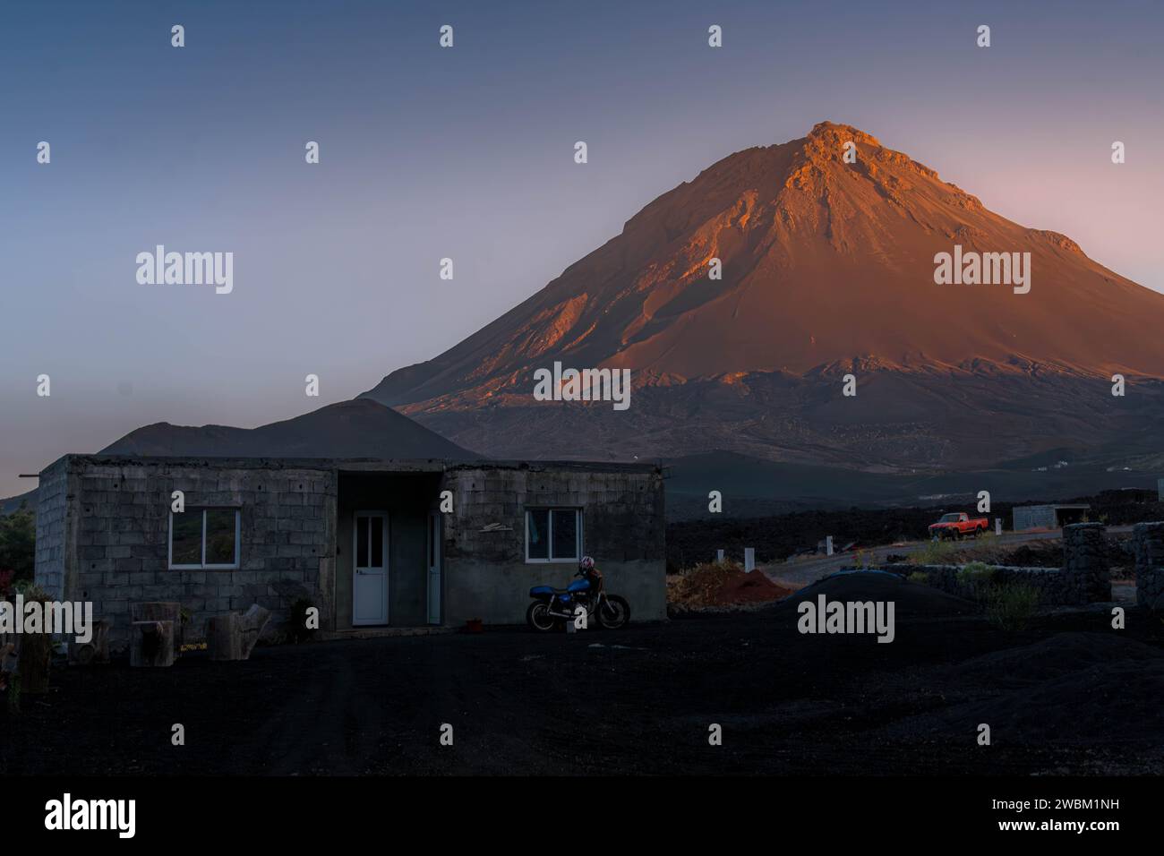 The small house with motorbike on the lava field in front of Pico do ...