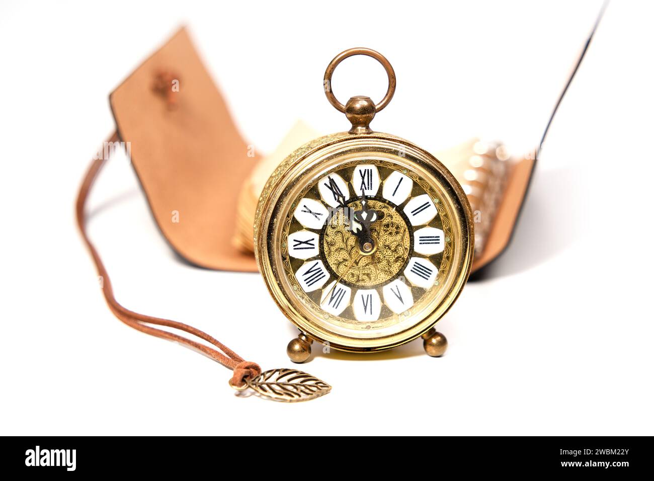 an old golden analog alarm clock with mechanical movement isolated on a ...
