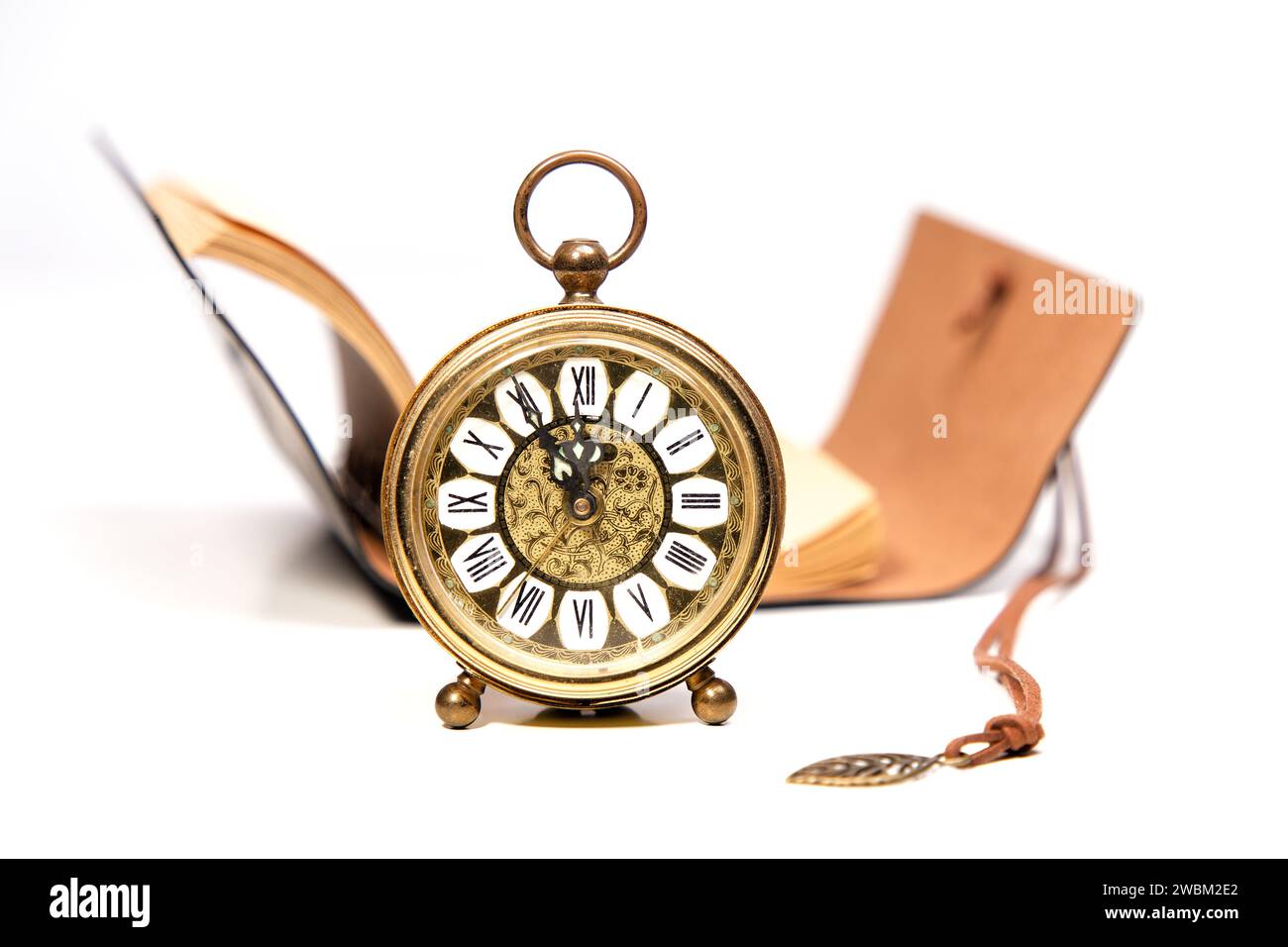 an old golden analog alarm clock with mechanical movement isolated on a ...