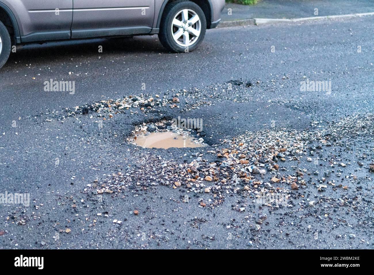 Pothole (pot hole) in a road Stock Photo - Alamy