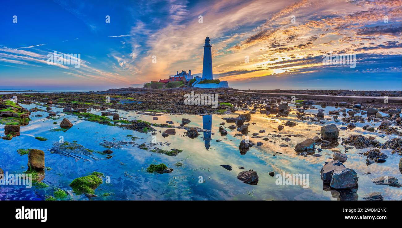 View of St Mary's Lighthouse at sunrise in mid-summer at low tide ...