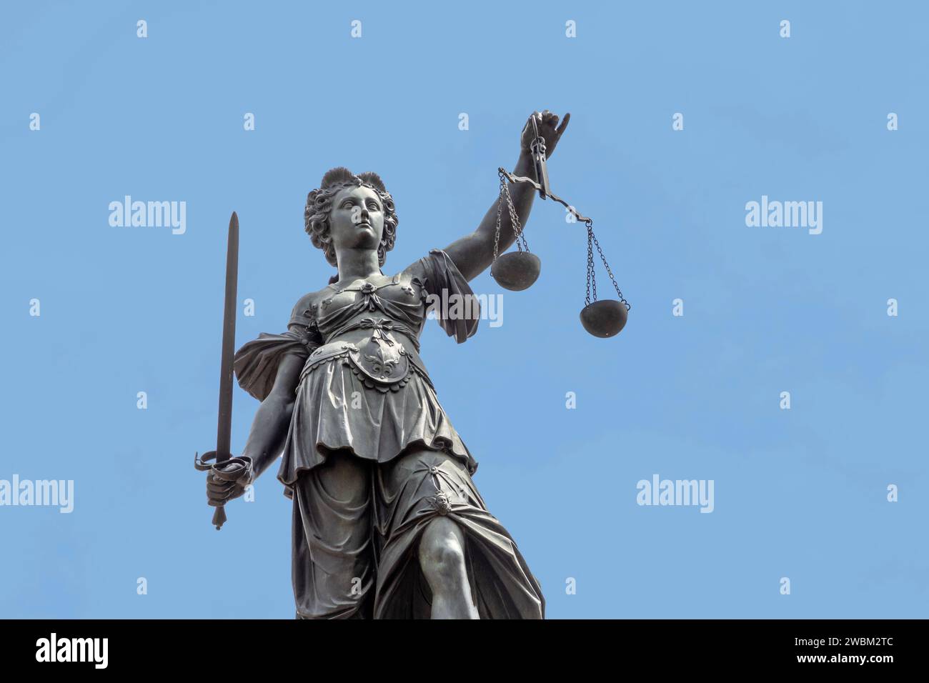 lady justice with sword and balance wage in Frankfurt under blue sky ...