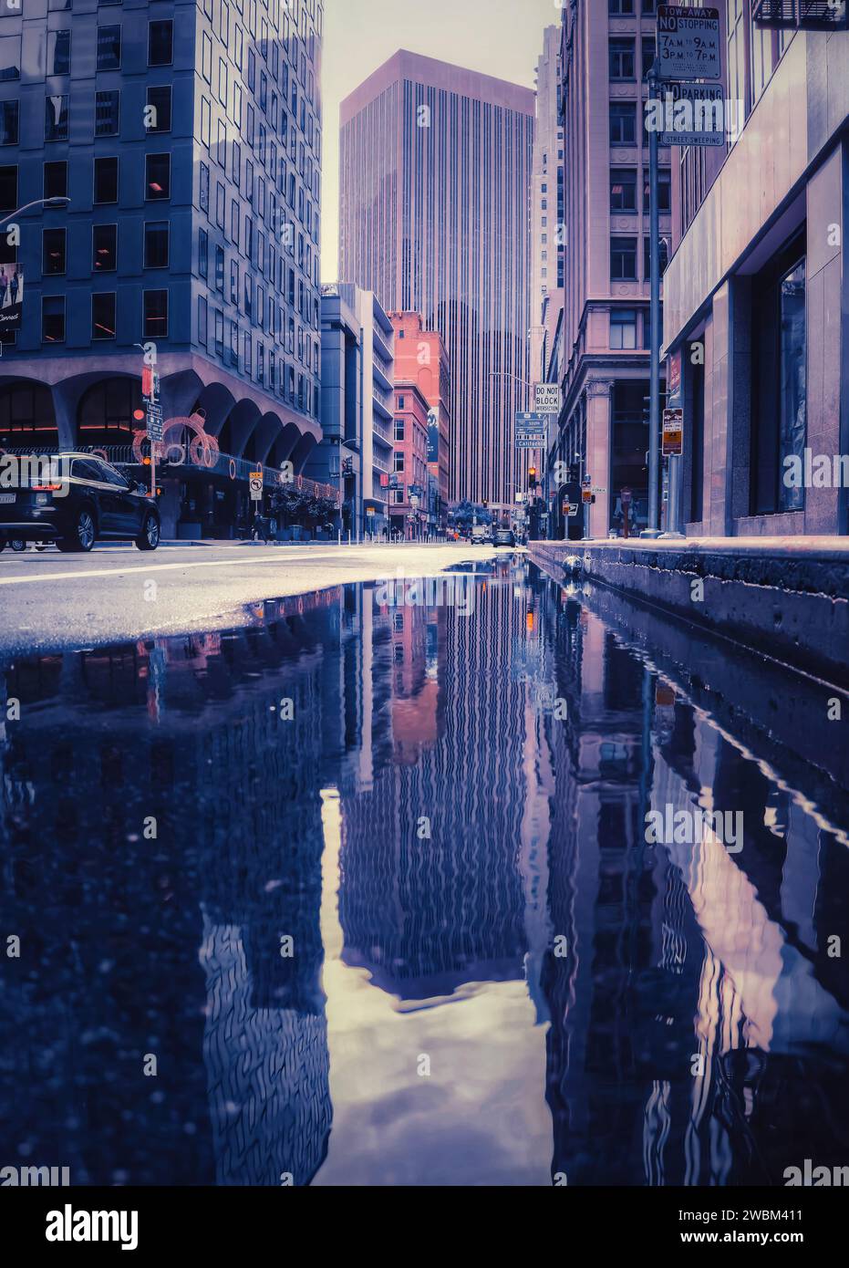 San Francisco downtown skylines and their reflection on a small puddle ...