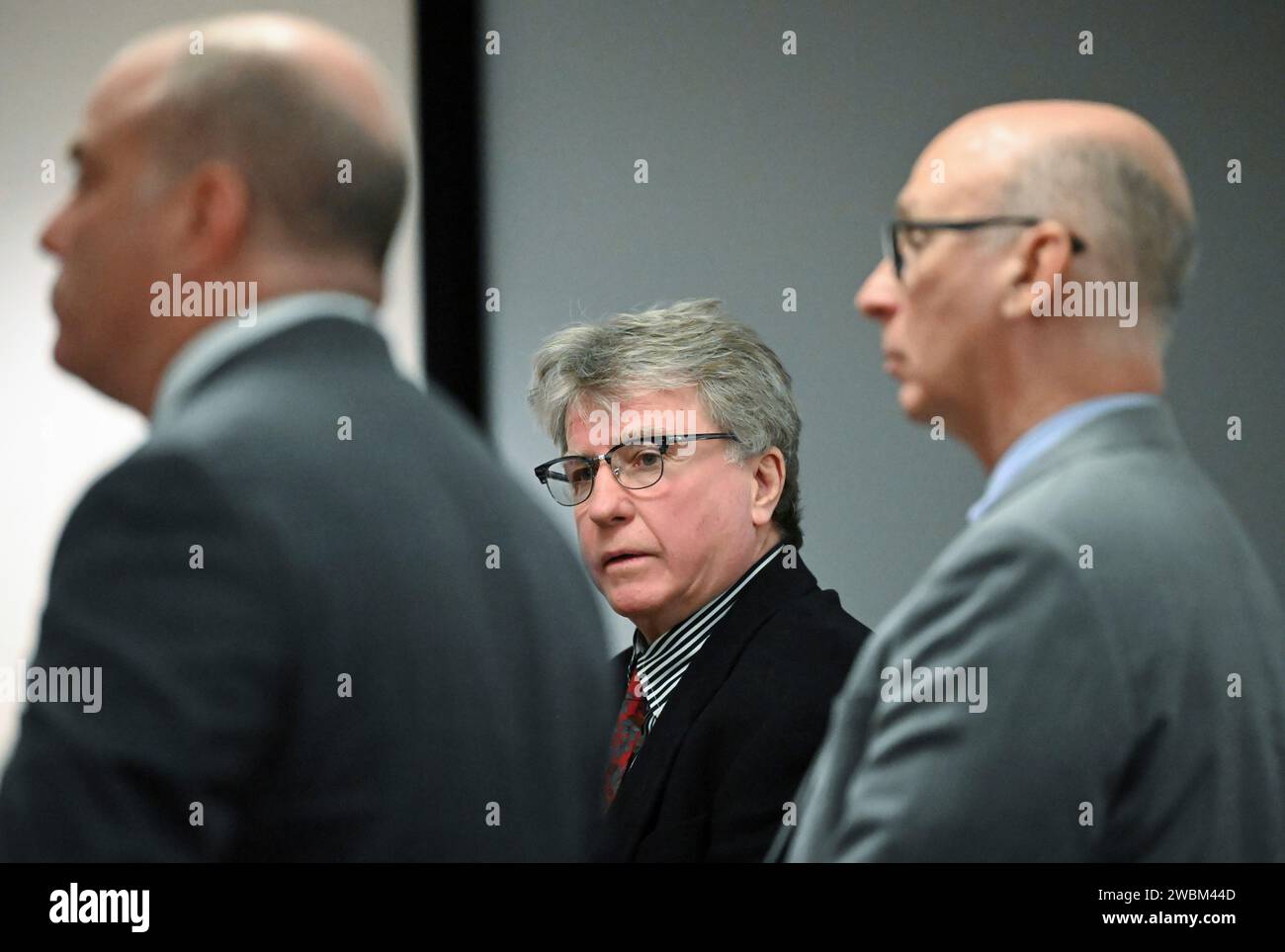 Defendant Kevin Monahan, center, is flanked by his legal defense during ...