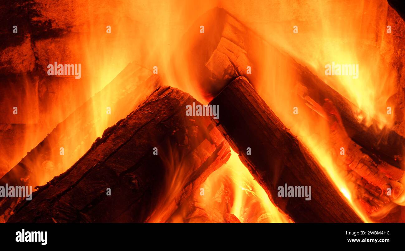 Wood burning in fireplace. Fire keep warm. Crest of flame on burning ...