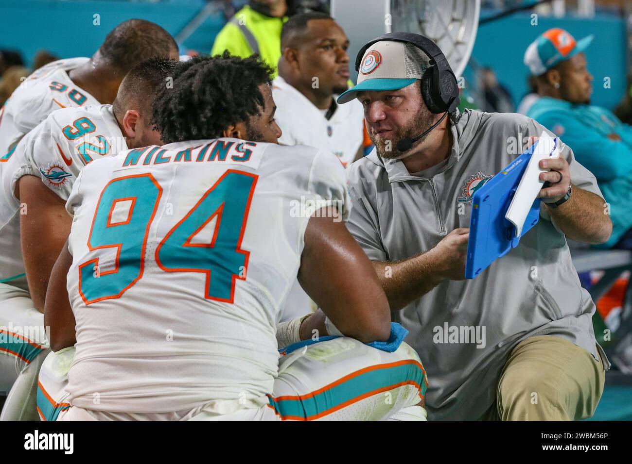 Miami Dolphins defensive line coach Austin Clark goes over plays with defensive tackle Christian ...