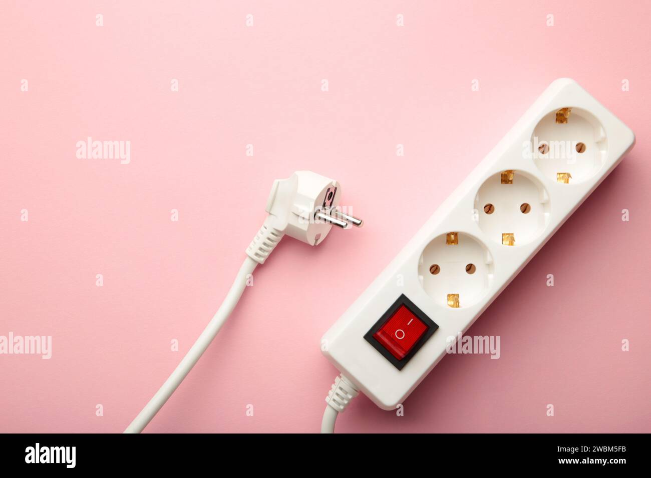 Electric white portable socket on pink background Stock Photo - Alamy