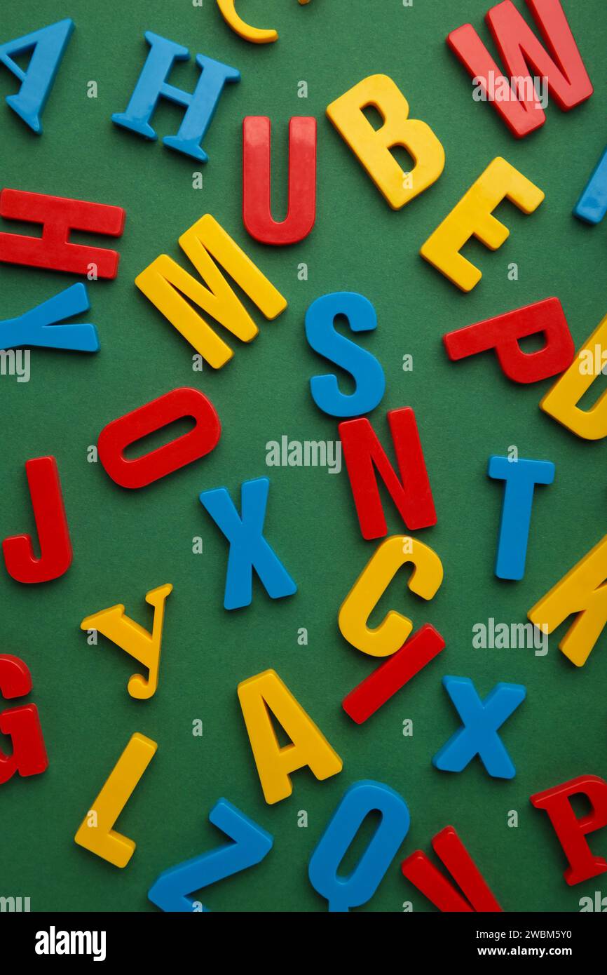 Magnetic plastic alphabet letters on green background. Top view Stock ...