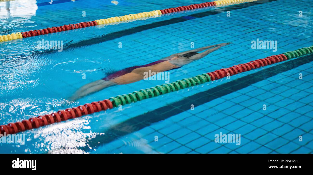 Successful professional female swimmer swimming butterfly stroke in the ...