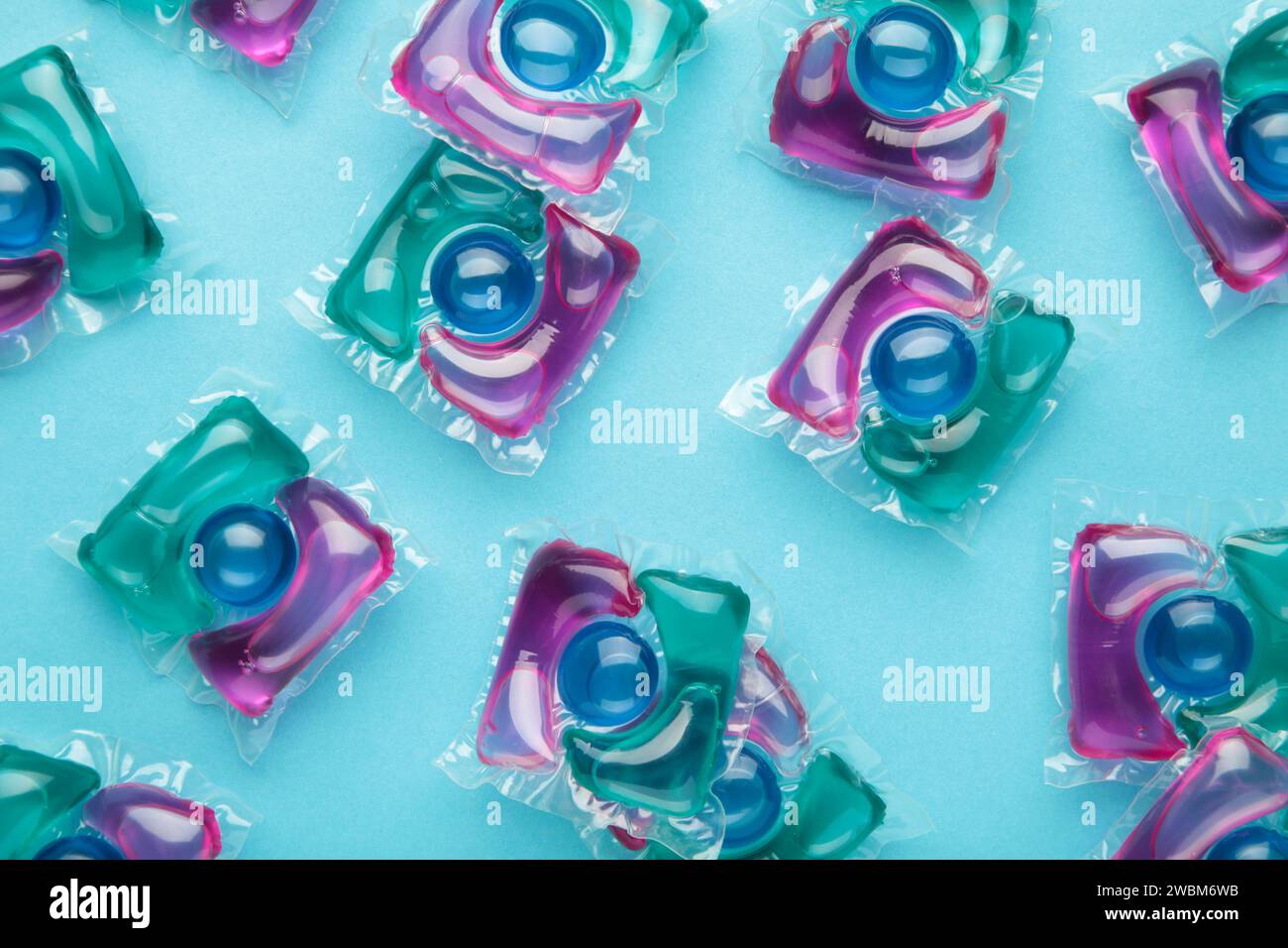 Laundry capsule detergent pods for washing clothes on blue background ...