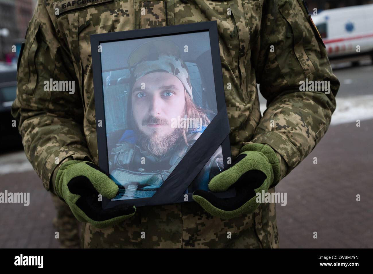 KYIV, UKRAINE - JANUARY 11, 2024 - A serviceman holds a portrait of ...