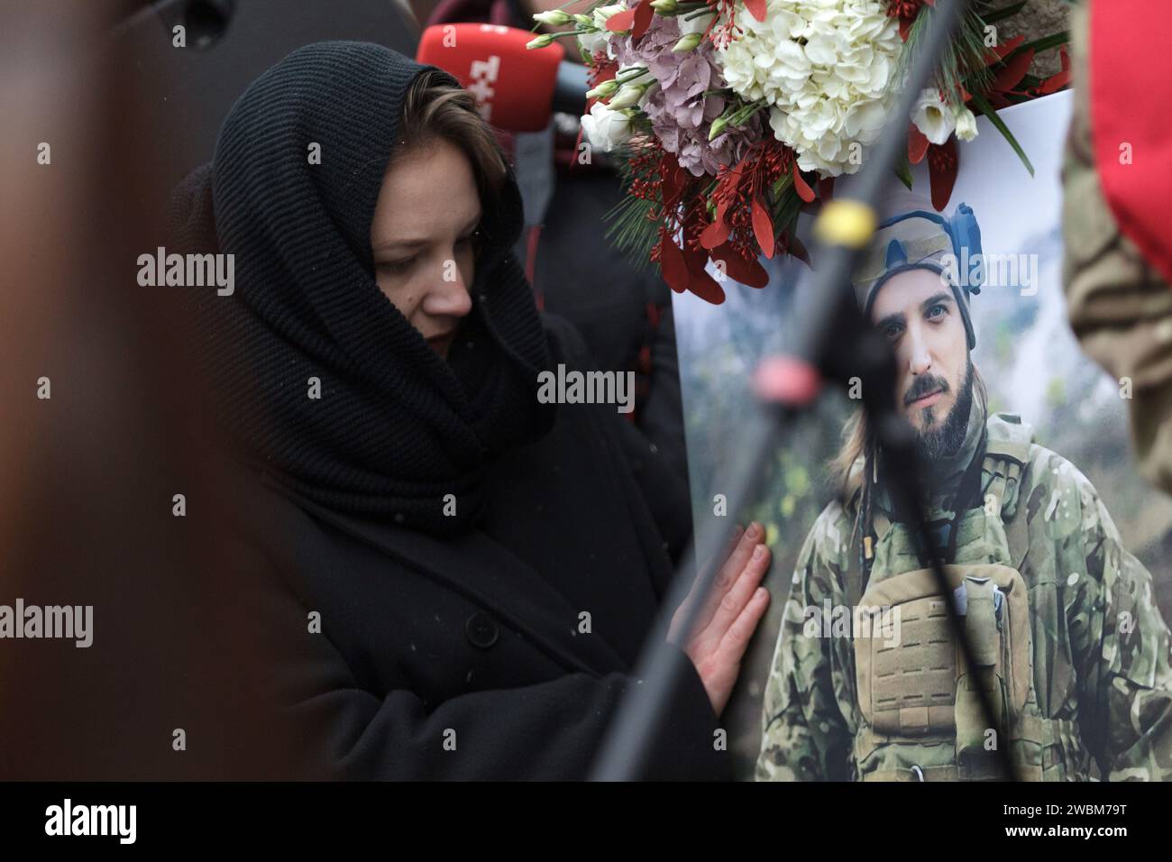 KYIV, UKRAINE - JANUARY 11, 2024 - A woman touches the portrait of ...