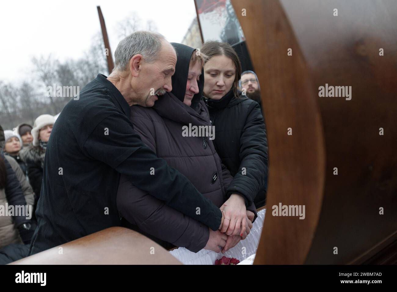KYIV, UKRAINE - JANUARY 11, 2024 - People grieve by the coffin of ...