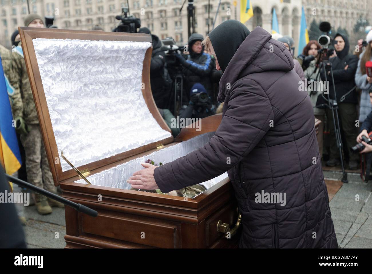 KYIV, UKRAINE - JANUARY 11, 2024 - A woman grieves by the coffin of ...